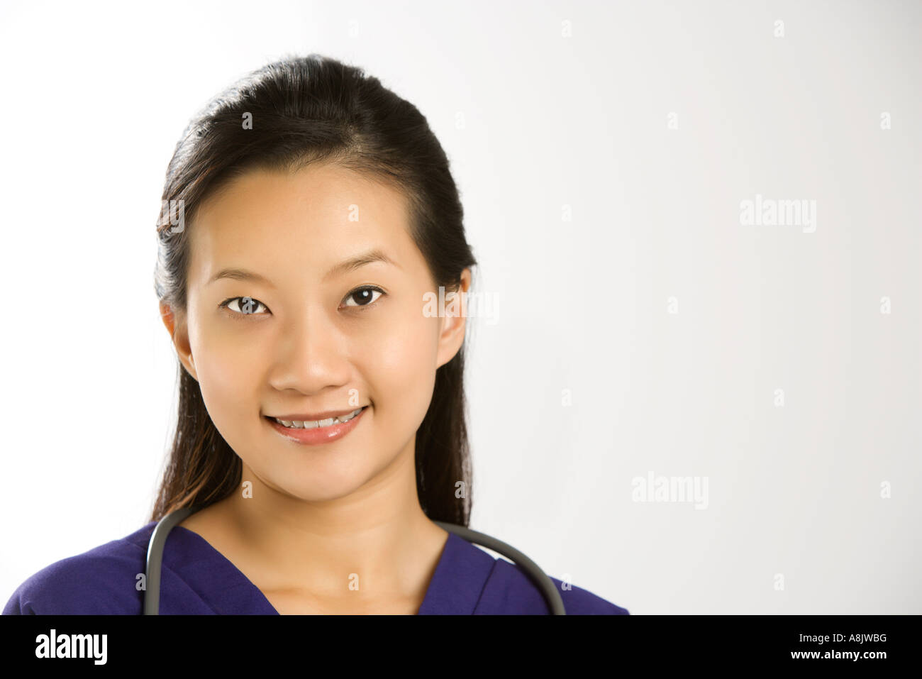Portrait of Asian Chinese mid adult female doctor smiling and looking ...