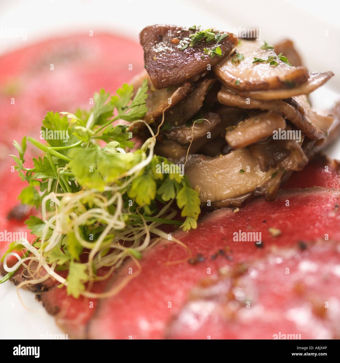 Pepper charred beef carpaccio with mushrooms Stock Photo - Alamy