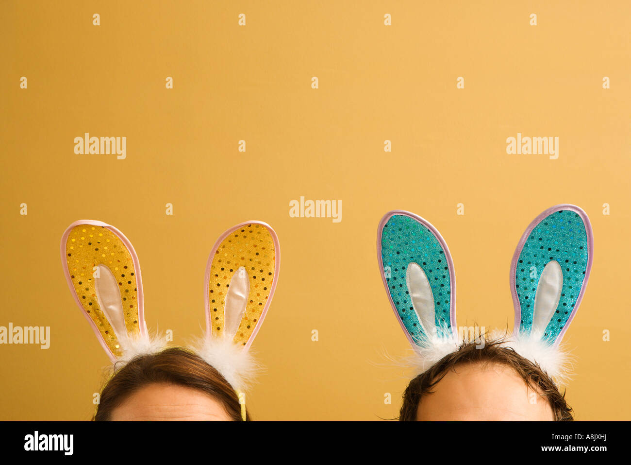 Caucasian mid adult couple wearing rabbit ears Stock Photo - Alamy