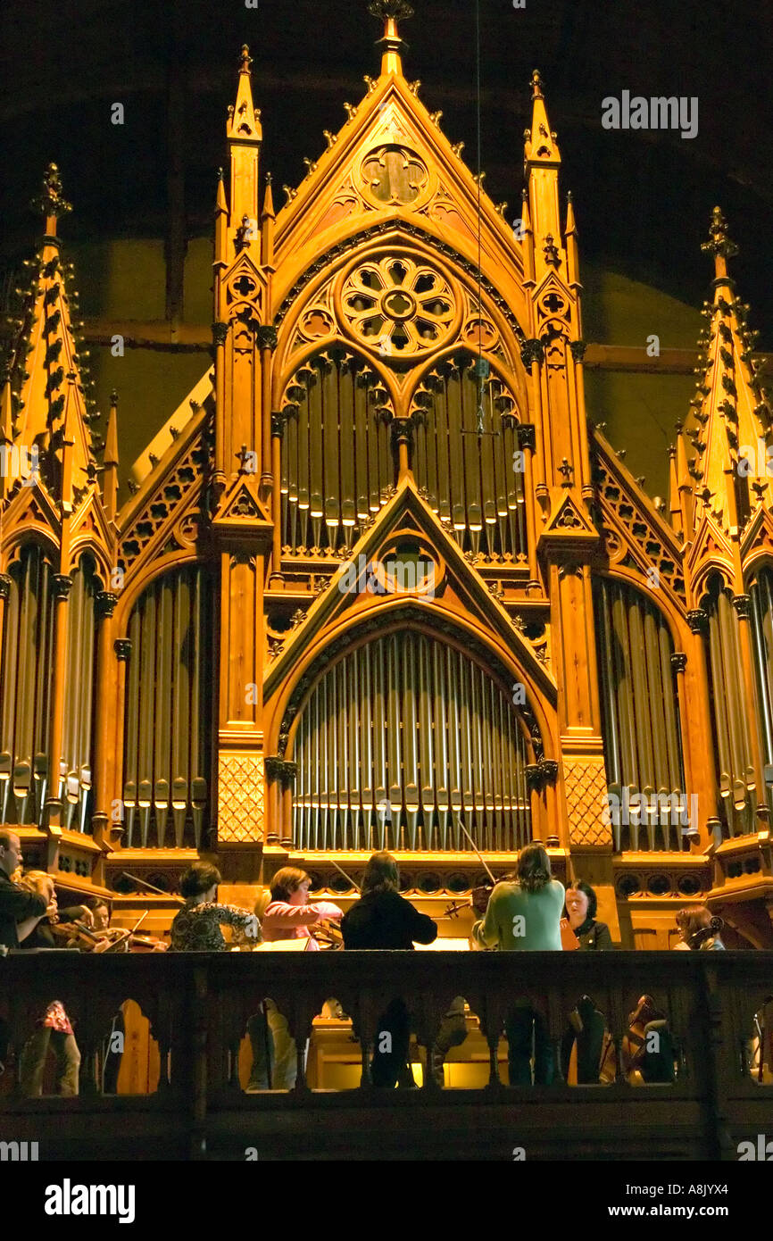 Baroque orchestra rehearsing Bach cantata in organ and choir loft of ...