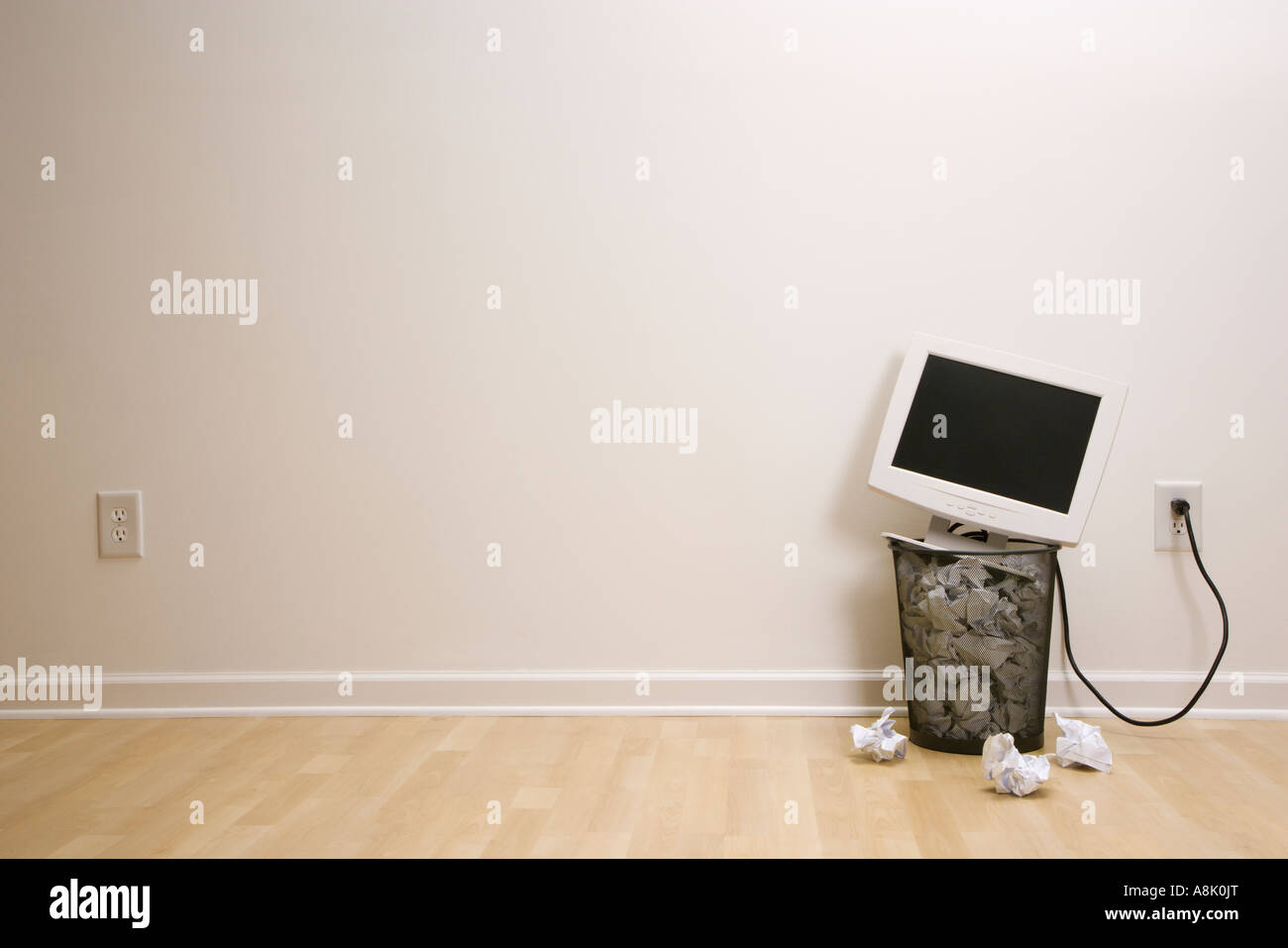 Computer monitor in trash can surrounded by crumpled up paper Stock ...