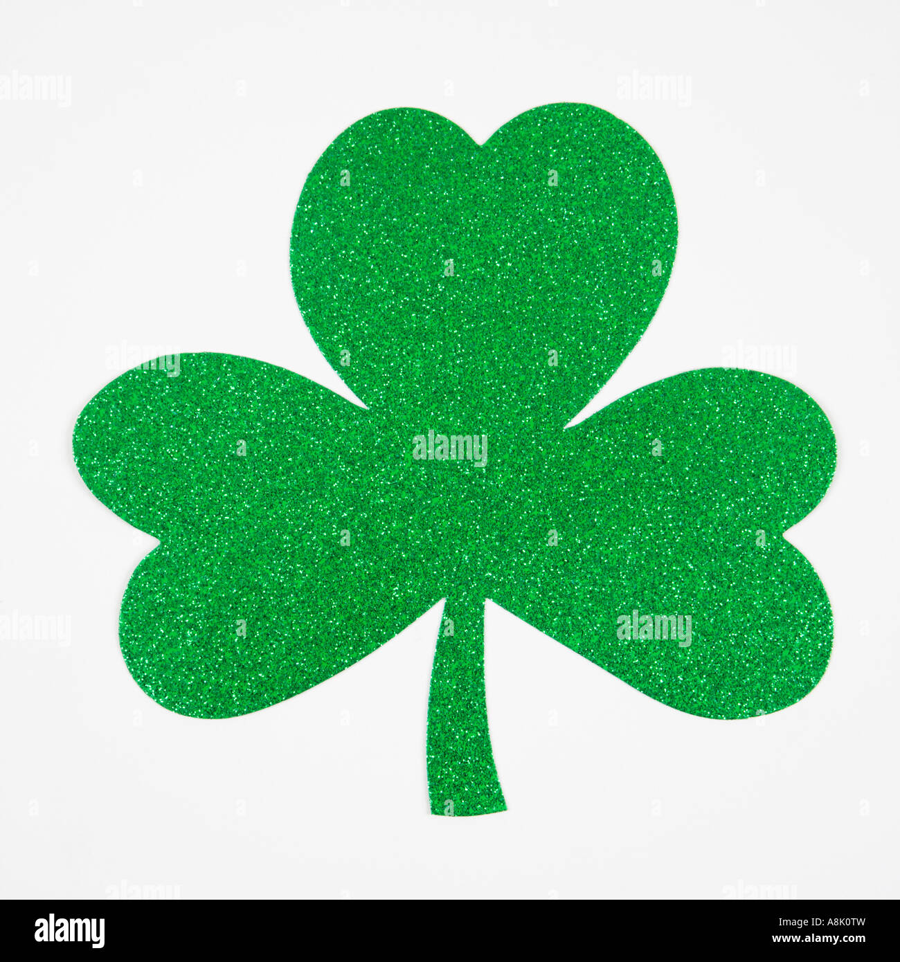 Green glitter paper shamrock on white Stock Photo - Alamy
