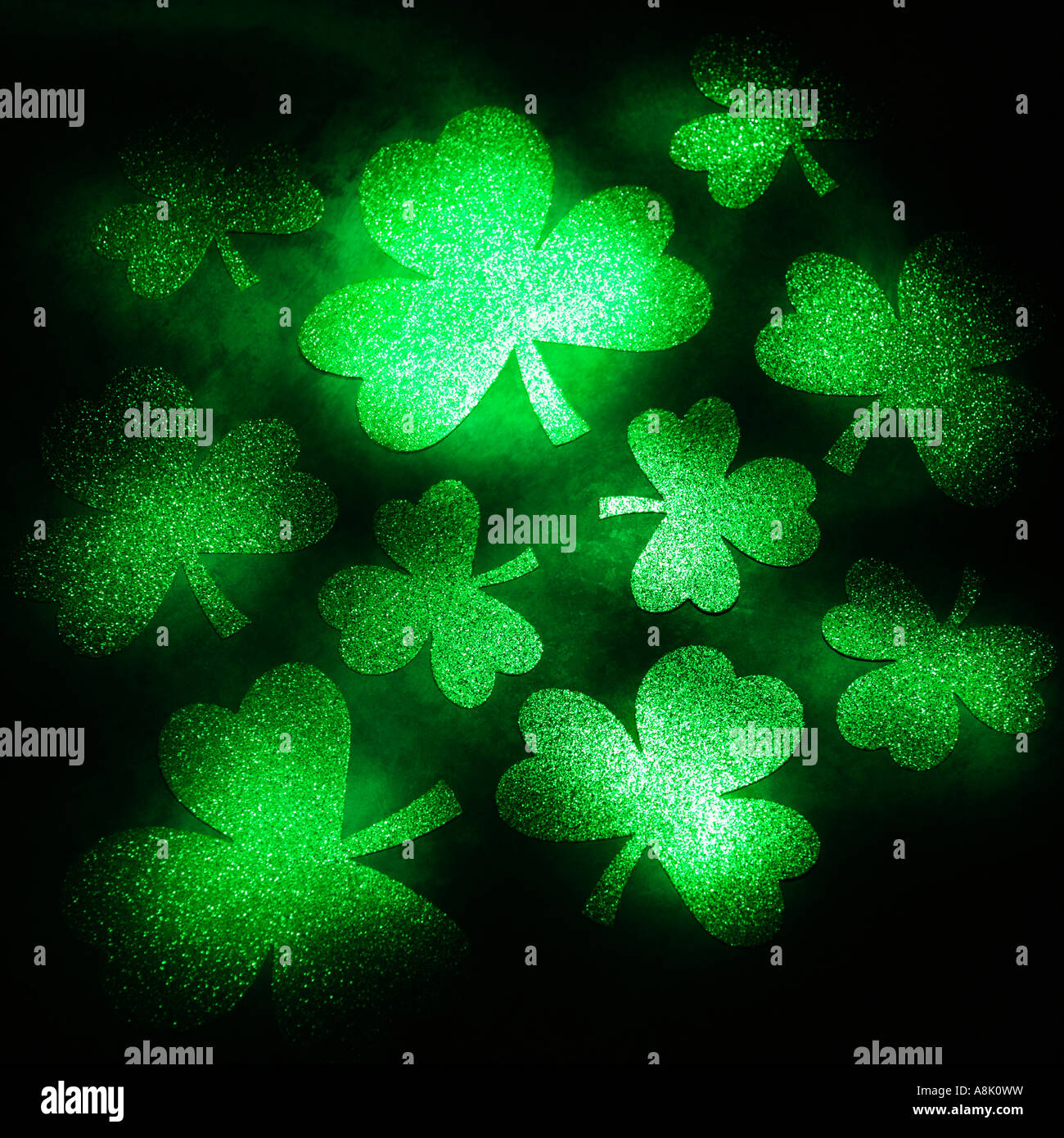 Group of green shamrocks reflecting light on black background Stock ...