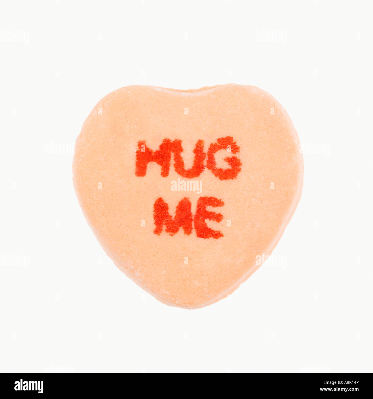 Orange candy heart that reads hug me against white background Stock ...
