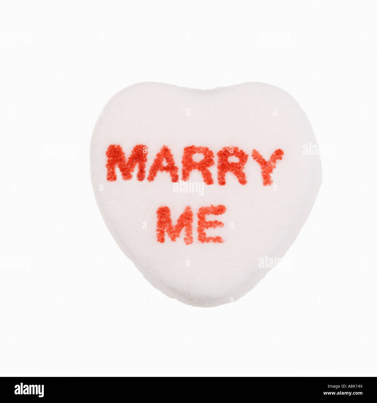 White candy heart that reads marry me against white background Stock ...
