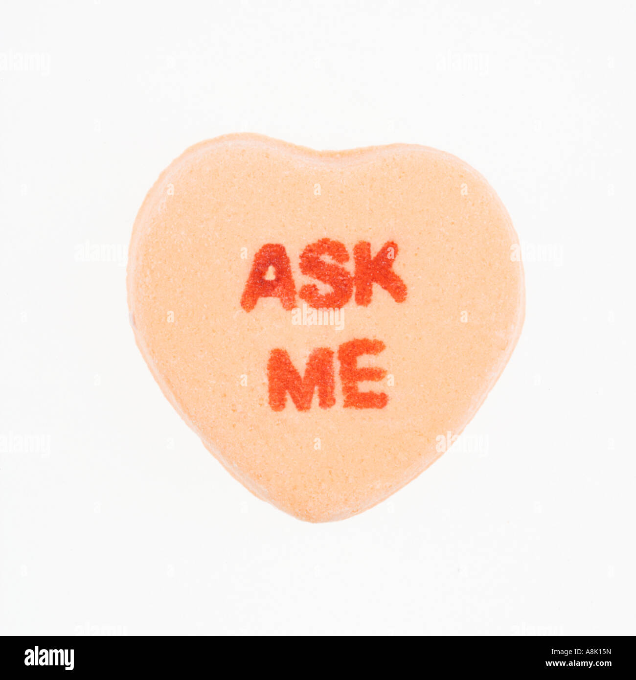 Orange candy heart that reads ask me against white background Stock ...