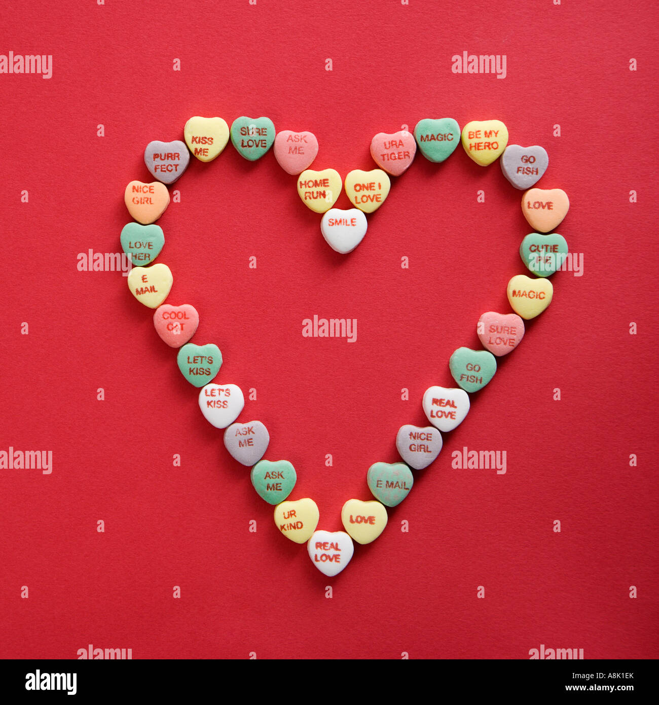 Colorful candy hearts with sayings on them arranged in shape of heart ...
