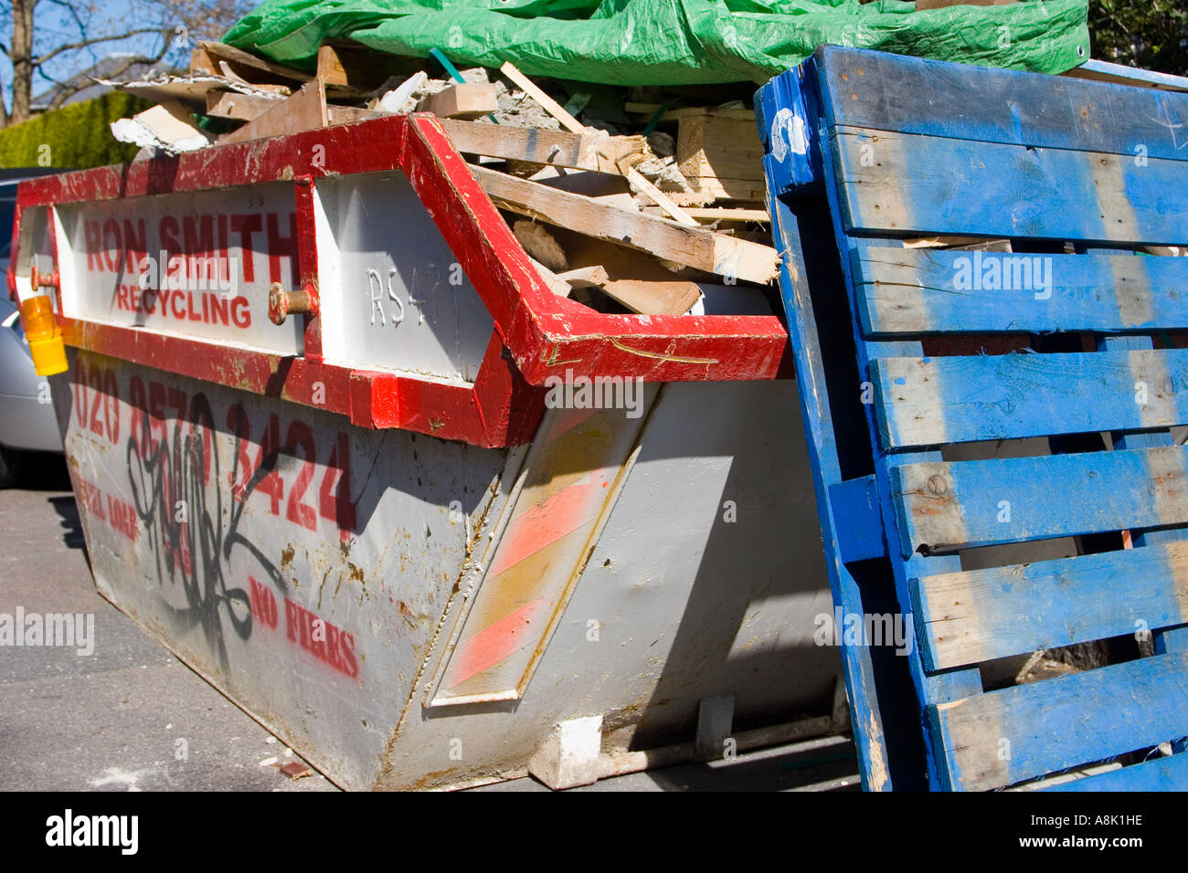 brightly coloured skip Stock Photo - Alamy