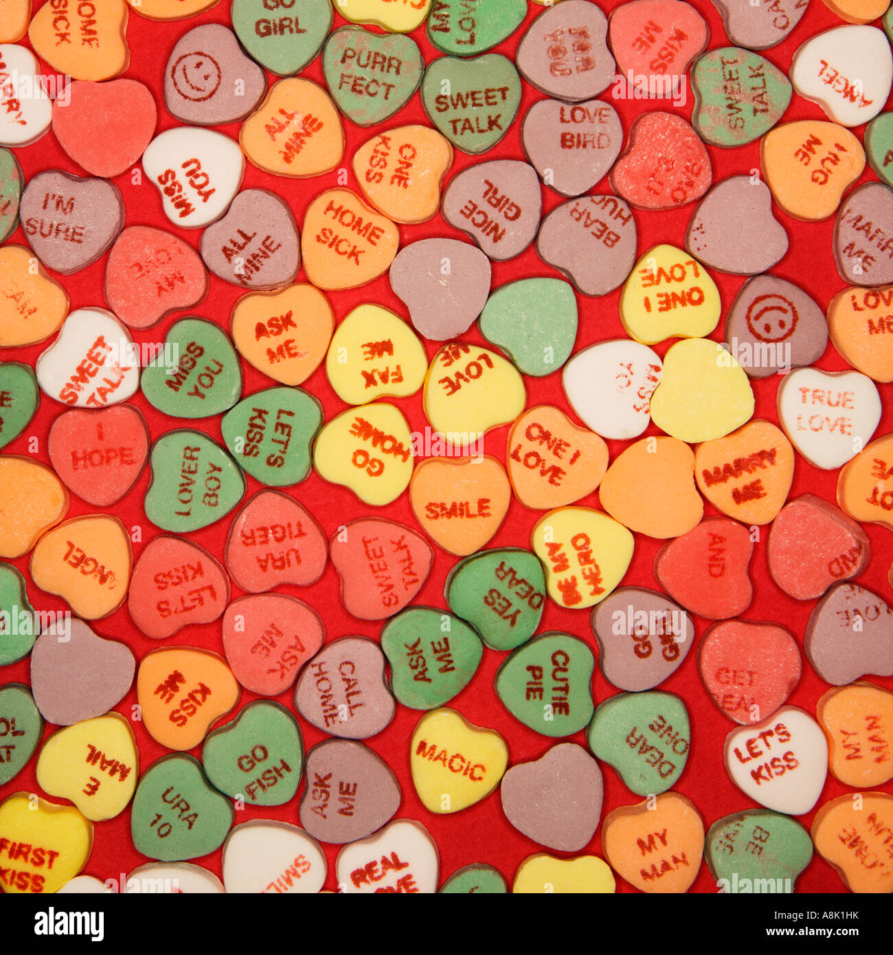Large group of colorful candy hearts with sayings on them arranged on ...