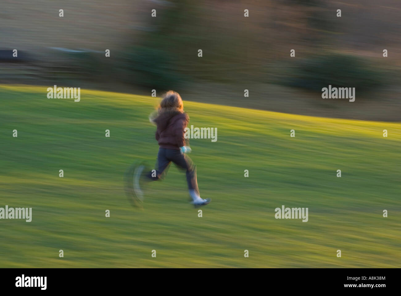 girl child running along parkland Stock Photo - Alamy