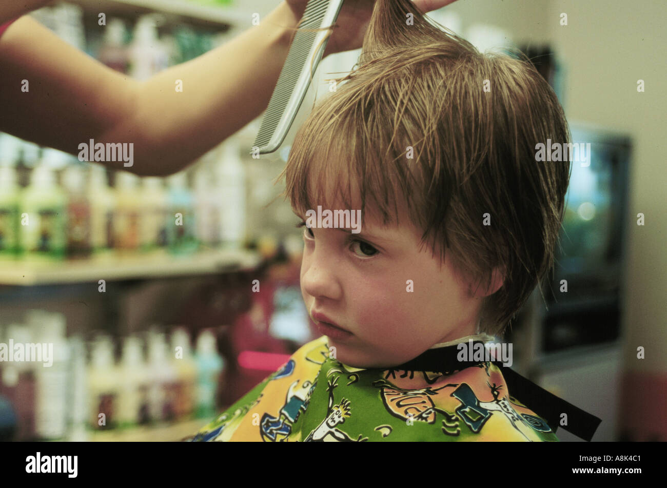sad young girl getting a haircut Stock Photo - Alamy