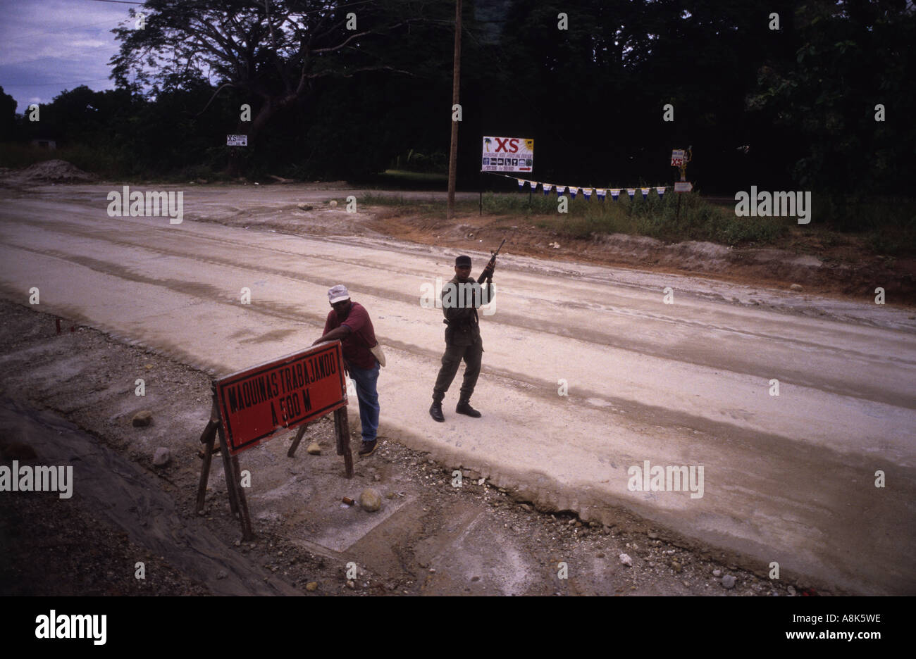 Panamanian police man a checkpoint with a machine gun while trying to ...