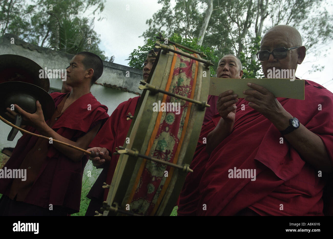Tibetan Monks chant and play instruments during a prayer and fire puja ...