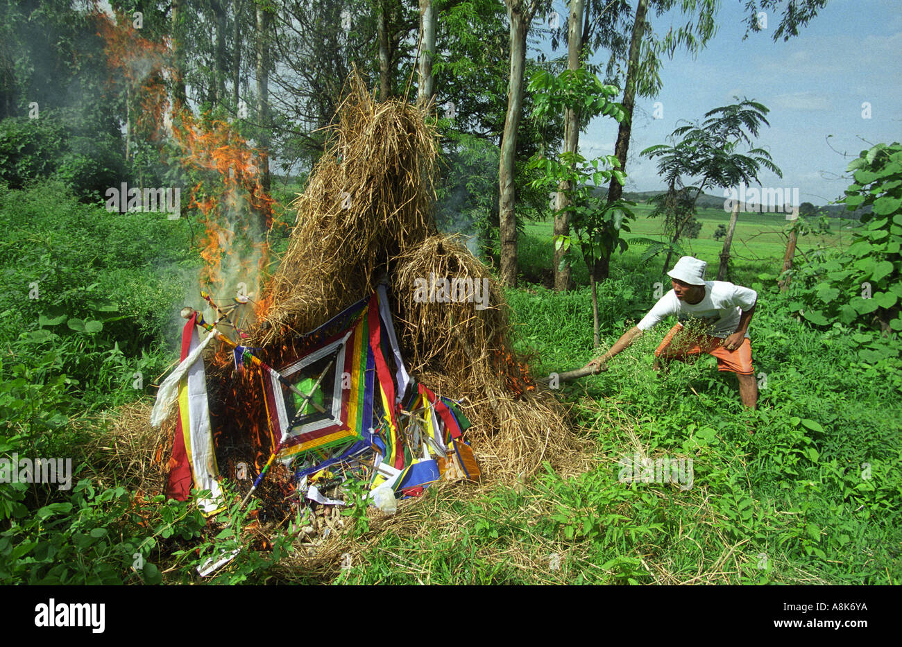 Tibetan monks set fire to an effigy during a fire puja for world peace ...