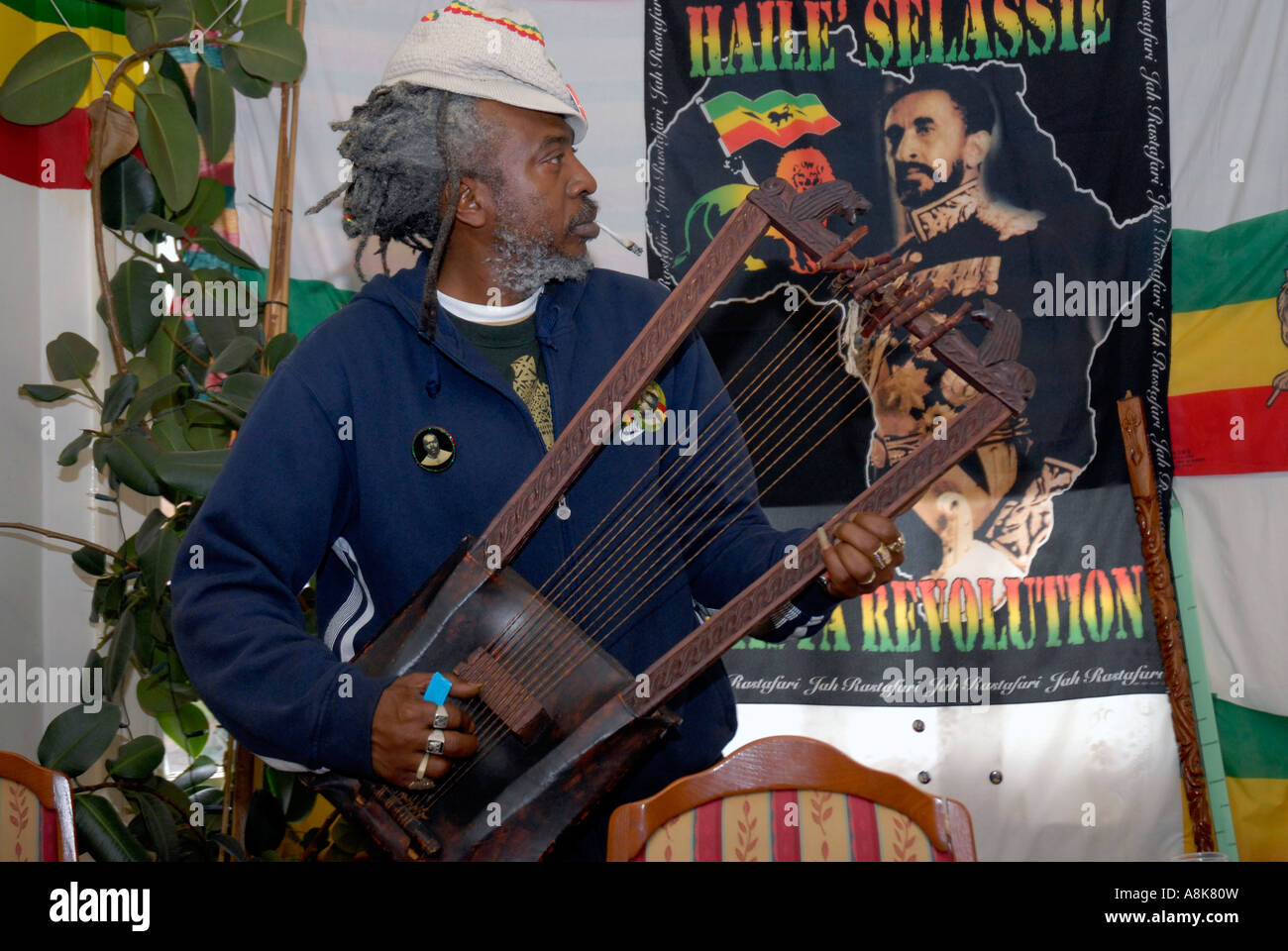 Rastafarian man playing traditional instrument in rasta Temple in ...