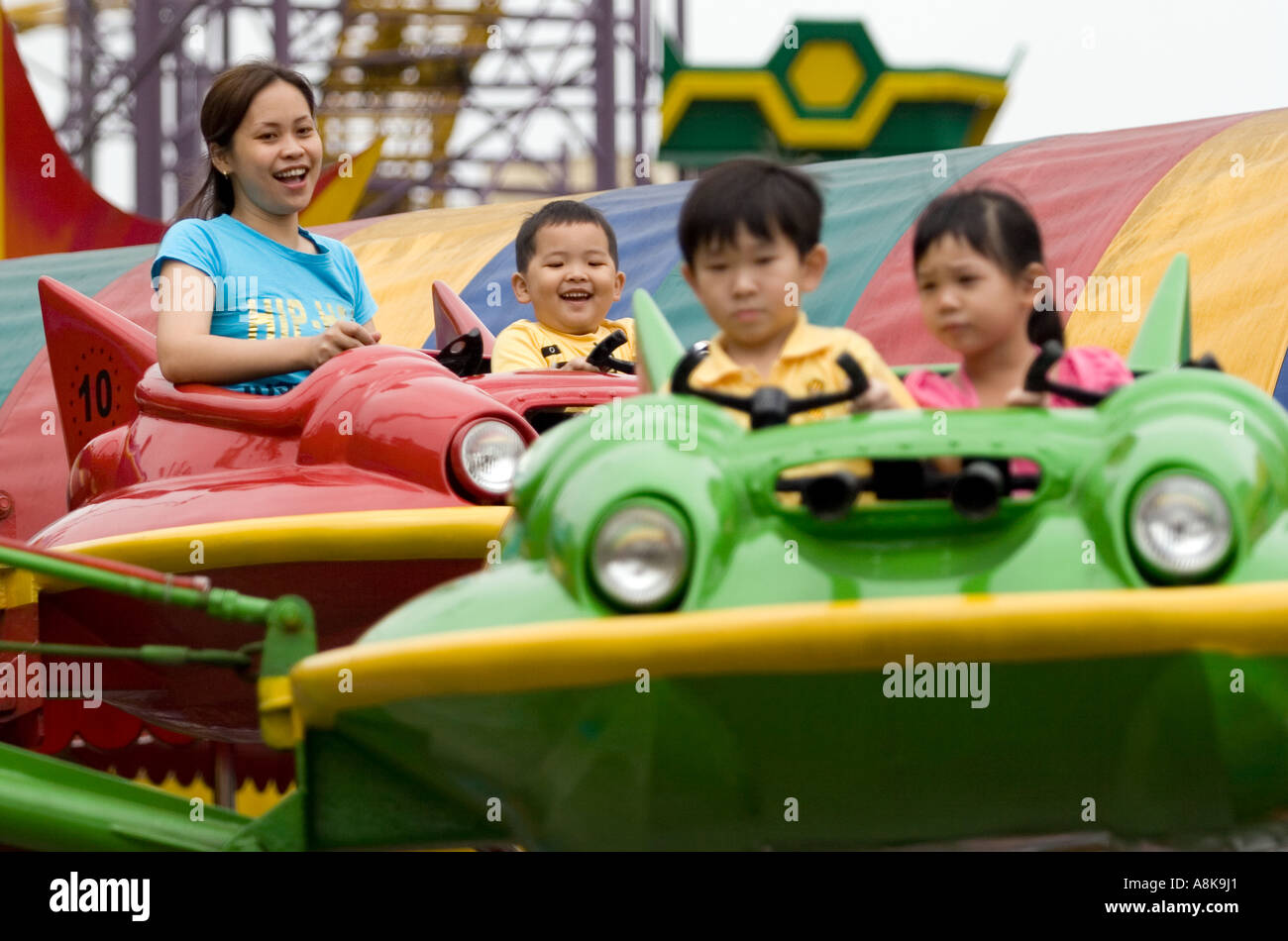 Mother and children enjoying the Astro Fighter ride at Genting ...