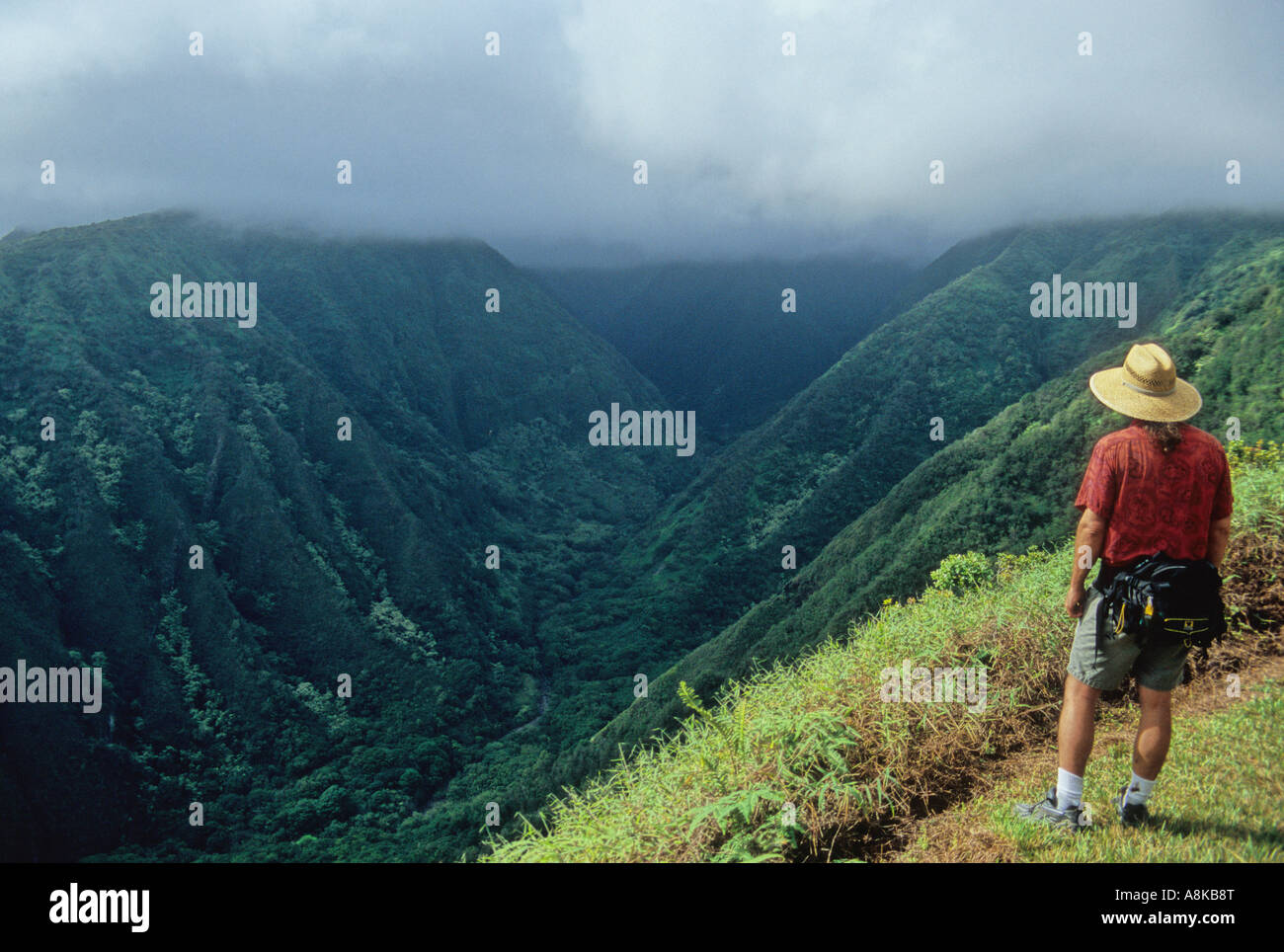 Hiker on the Waihee Ridge Trail looks down at Waihee Valley on Maui ...