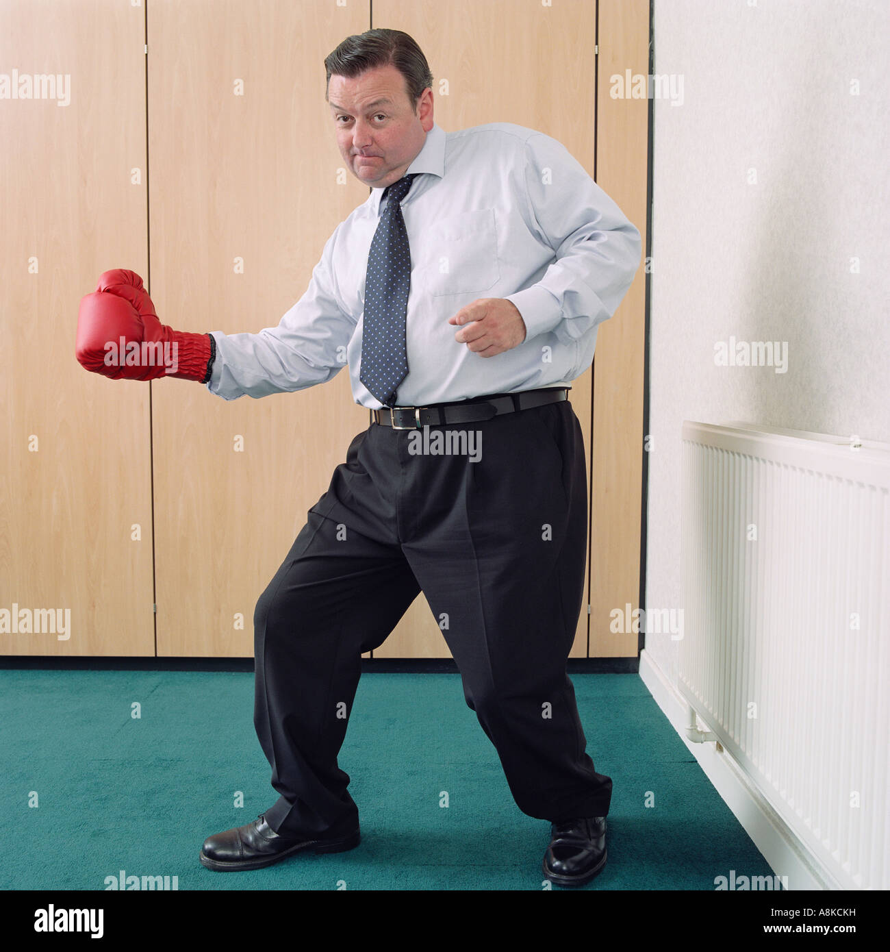 A businessman playing wearing a boxing glove in the office Stock Photo ...