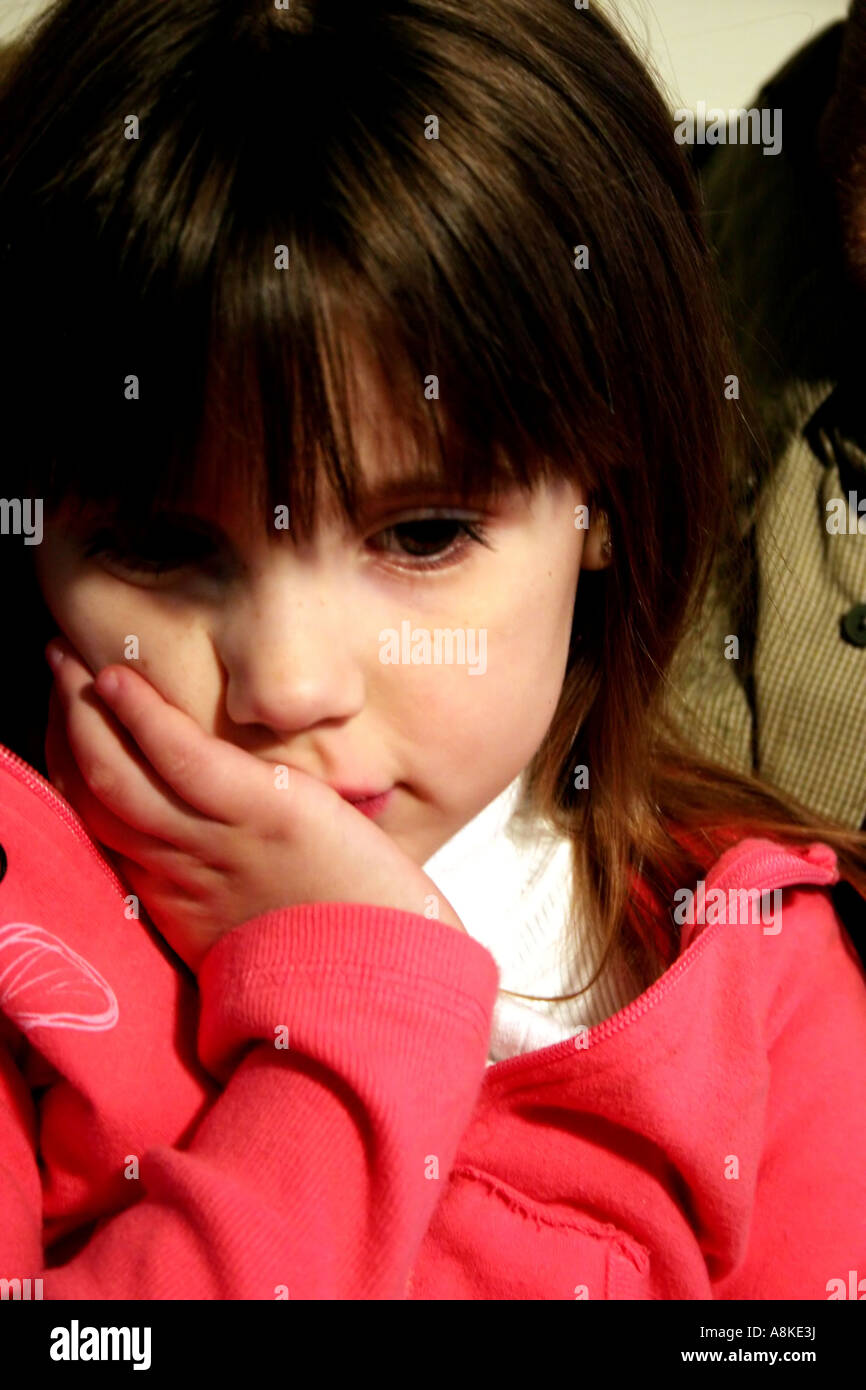 Young girl thinking with a serious and somber expression Stock Photo ...