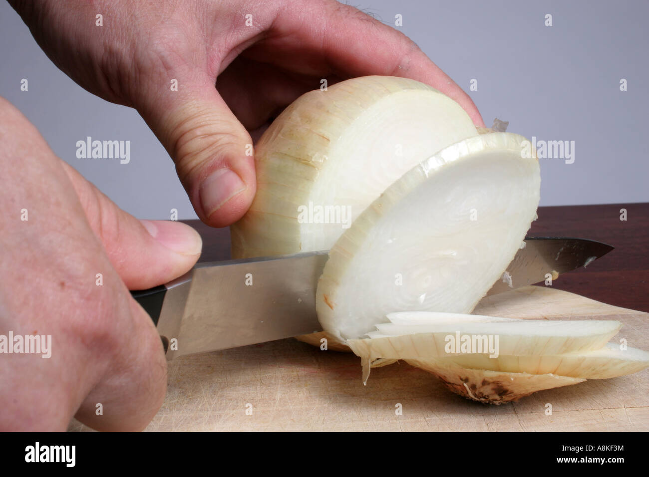 slice of sweet onion, being sliced for cooking Stock Photo - Alamy