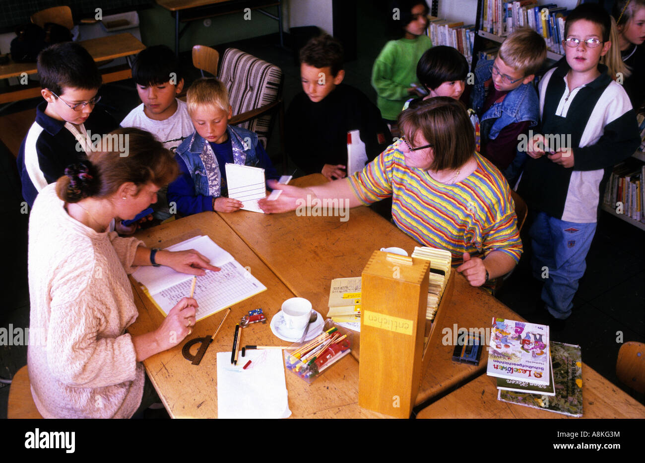 Children taking out books from a library in a school in Solingen, North ...