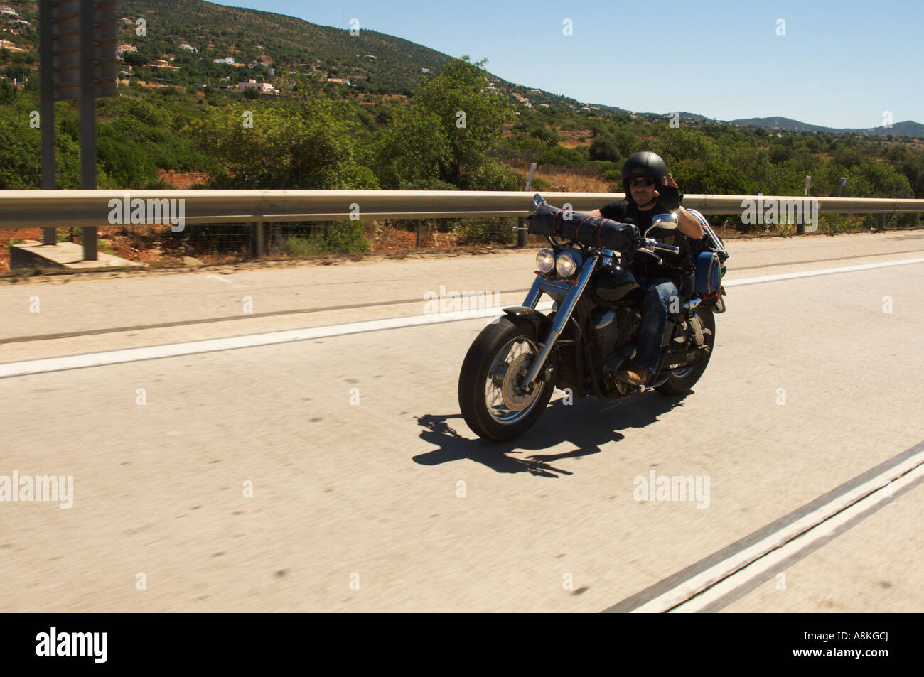 A biker leaving the Motorcycle Rally Faro Algarve Portugal Stock Photo ...
