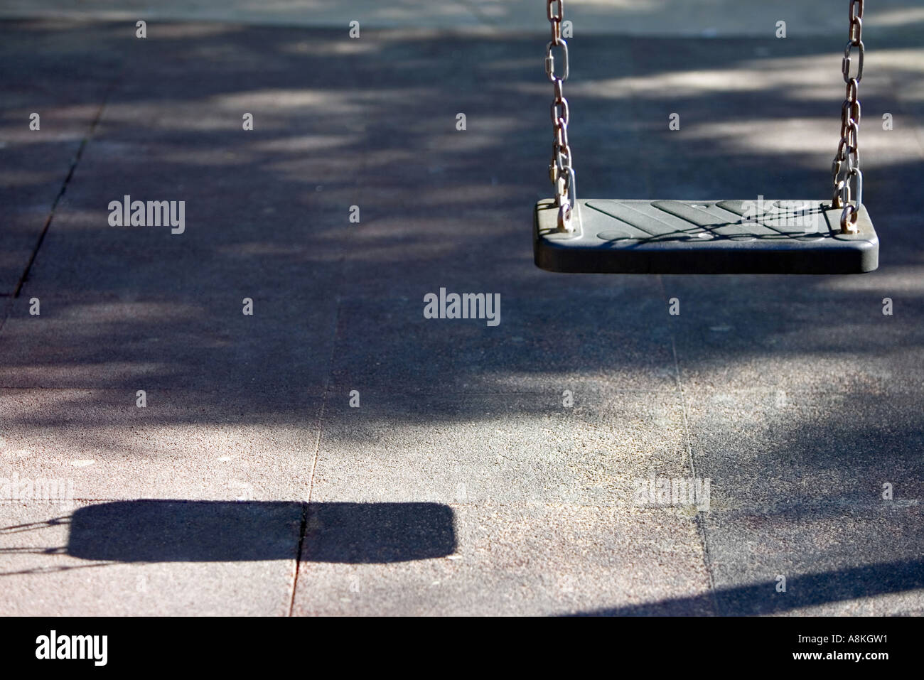 Single empty swing seat and shadow in childrens playground Stock Photo ...