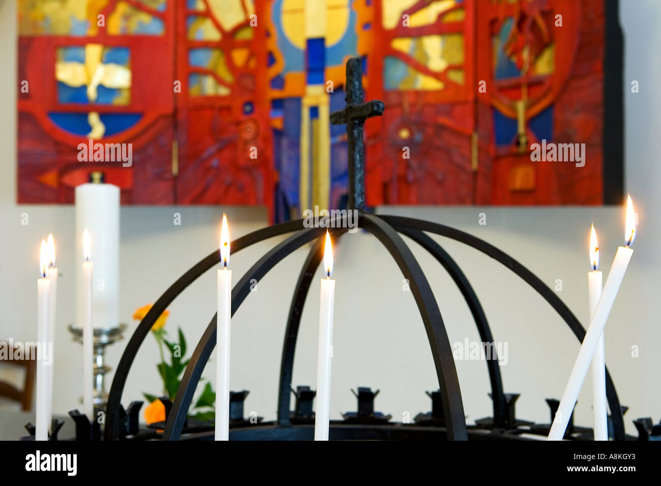 Interior of small colourful church with altar and candles close up ...