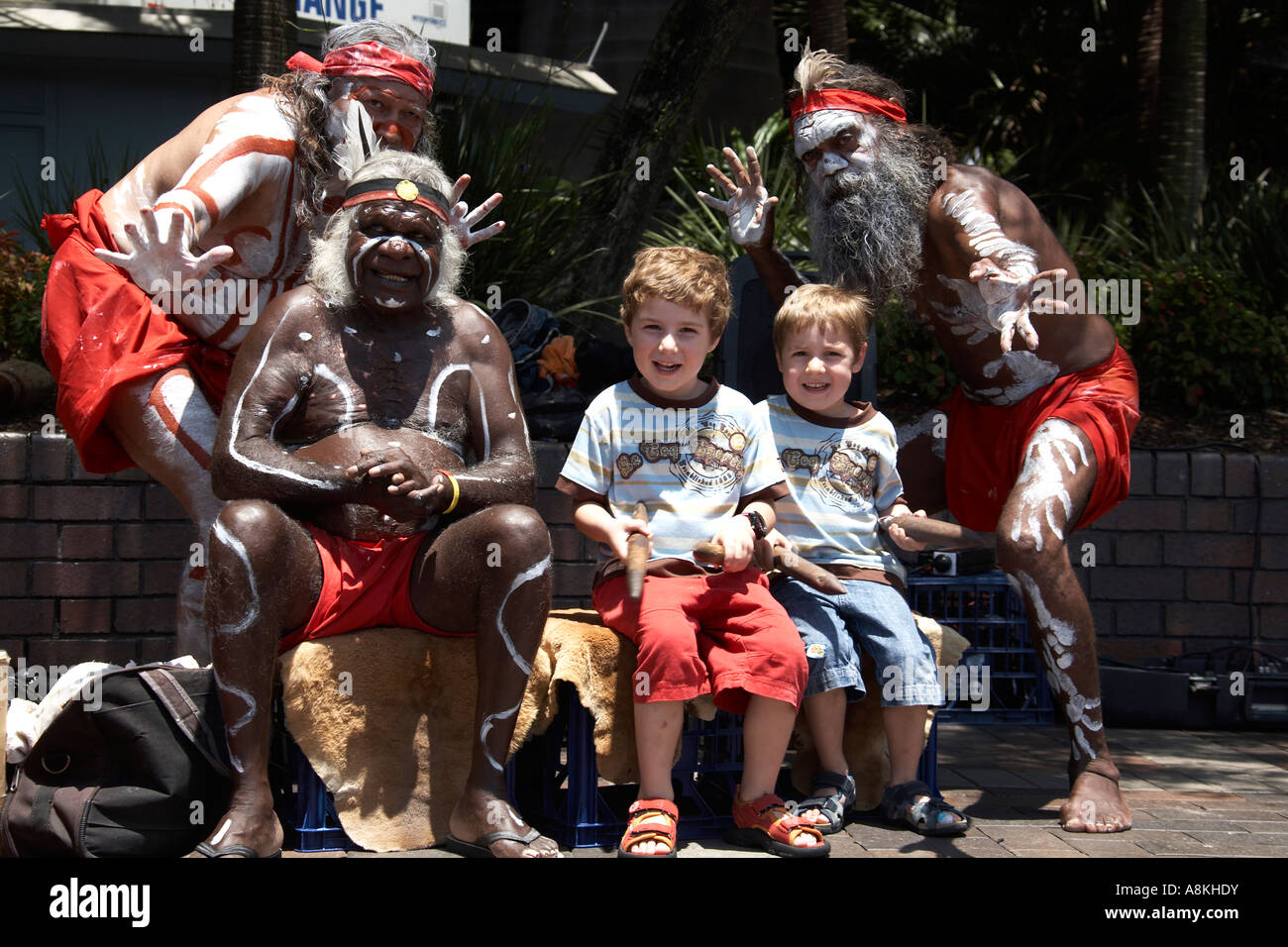 Aboriginal aborigine men busking and posing with two boys on Circular ...