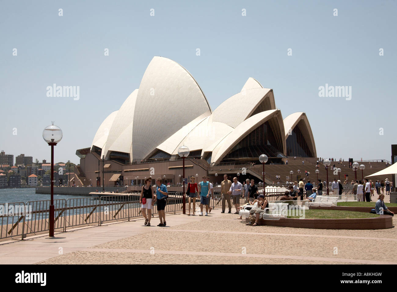 Opera House with people walking and sitting in sun in Sydney New South ...