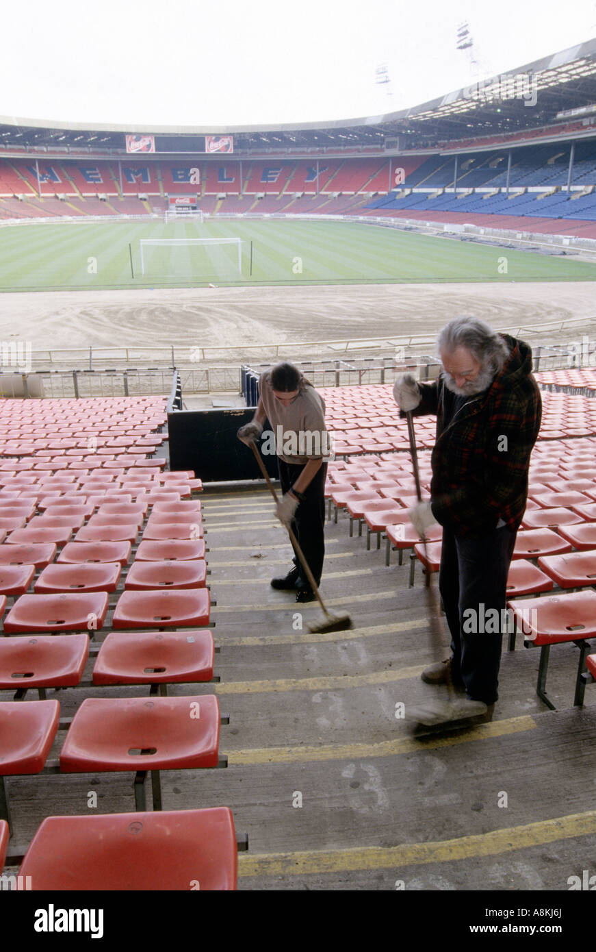 Sweeping the terraces at the old Wembley Stadium Stock Photo - Alamy