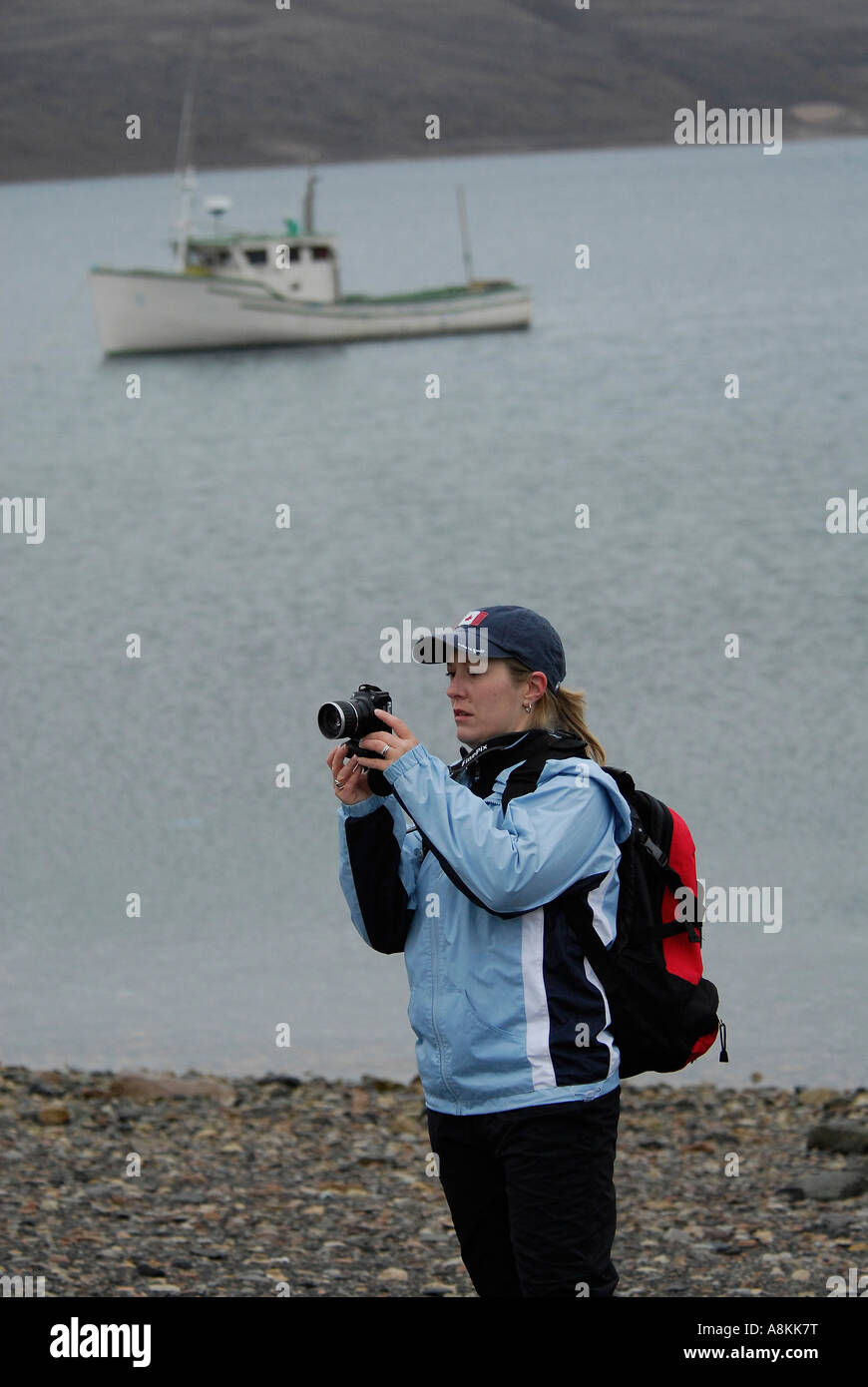 Tourist taking pictures at Coastal Inuit community of Arctic Bay ...