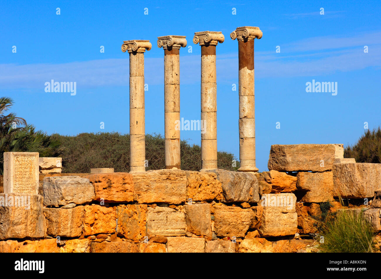 Four ancient columns with ionic capital, Ruins of the Roman City Leptis Magna, Libya Stock Photo ...