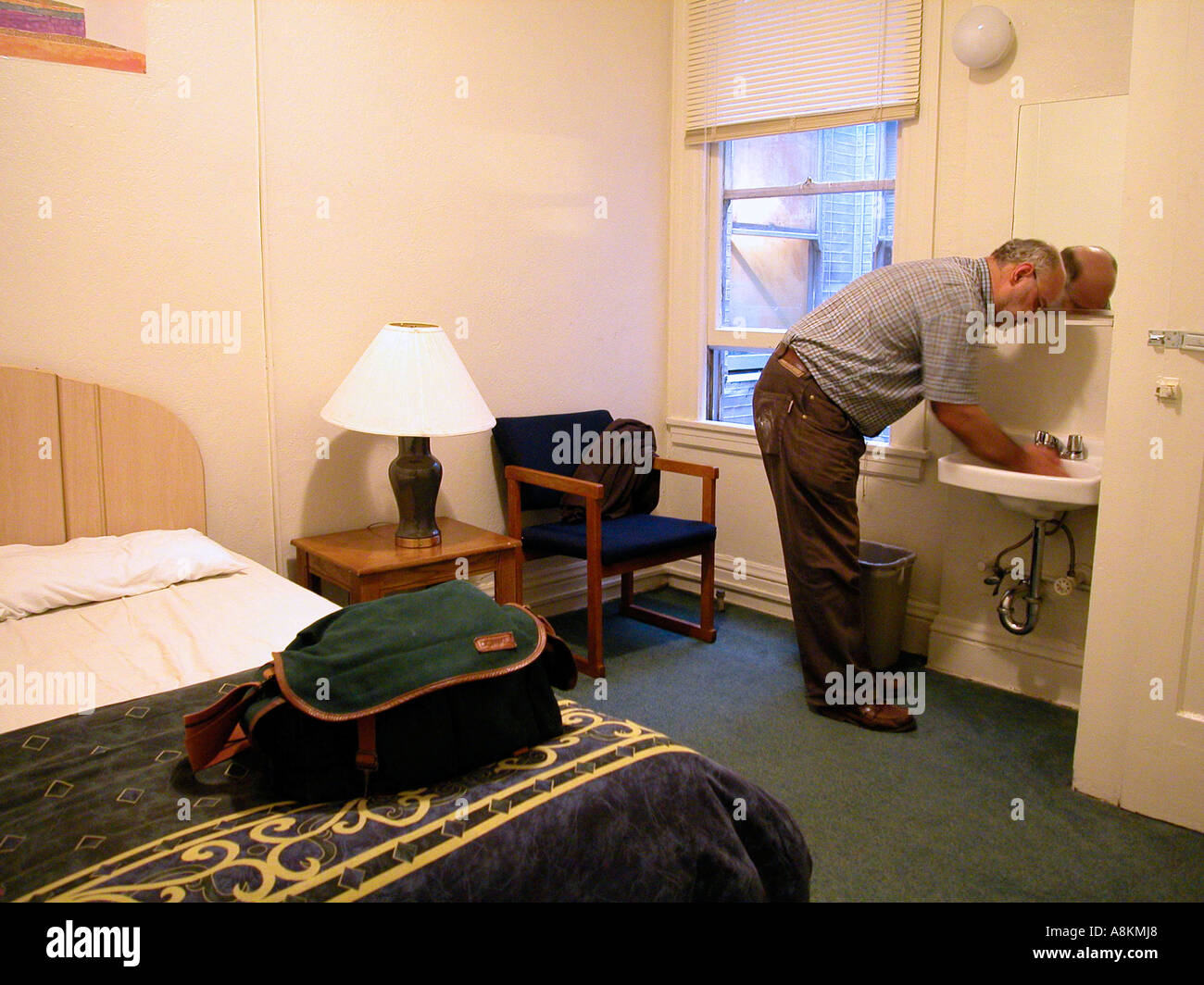 Elder male white traveler in a dorm room at a youth hostel in the Mason ...