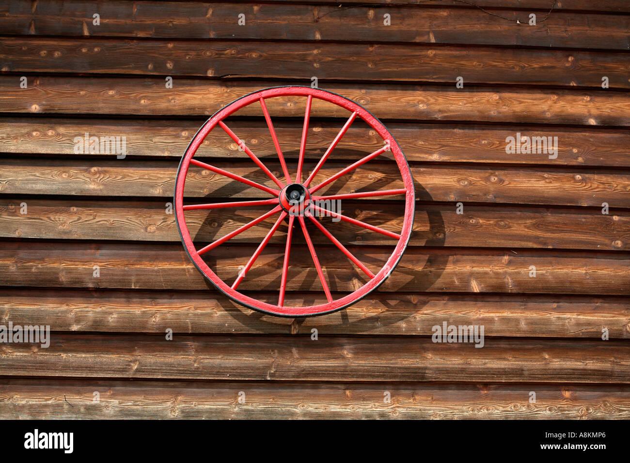 Traditional old-style antique red painted wheel decorating brown aged ...