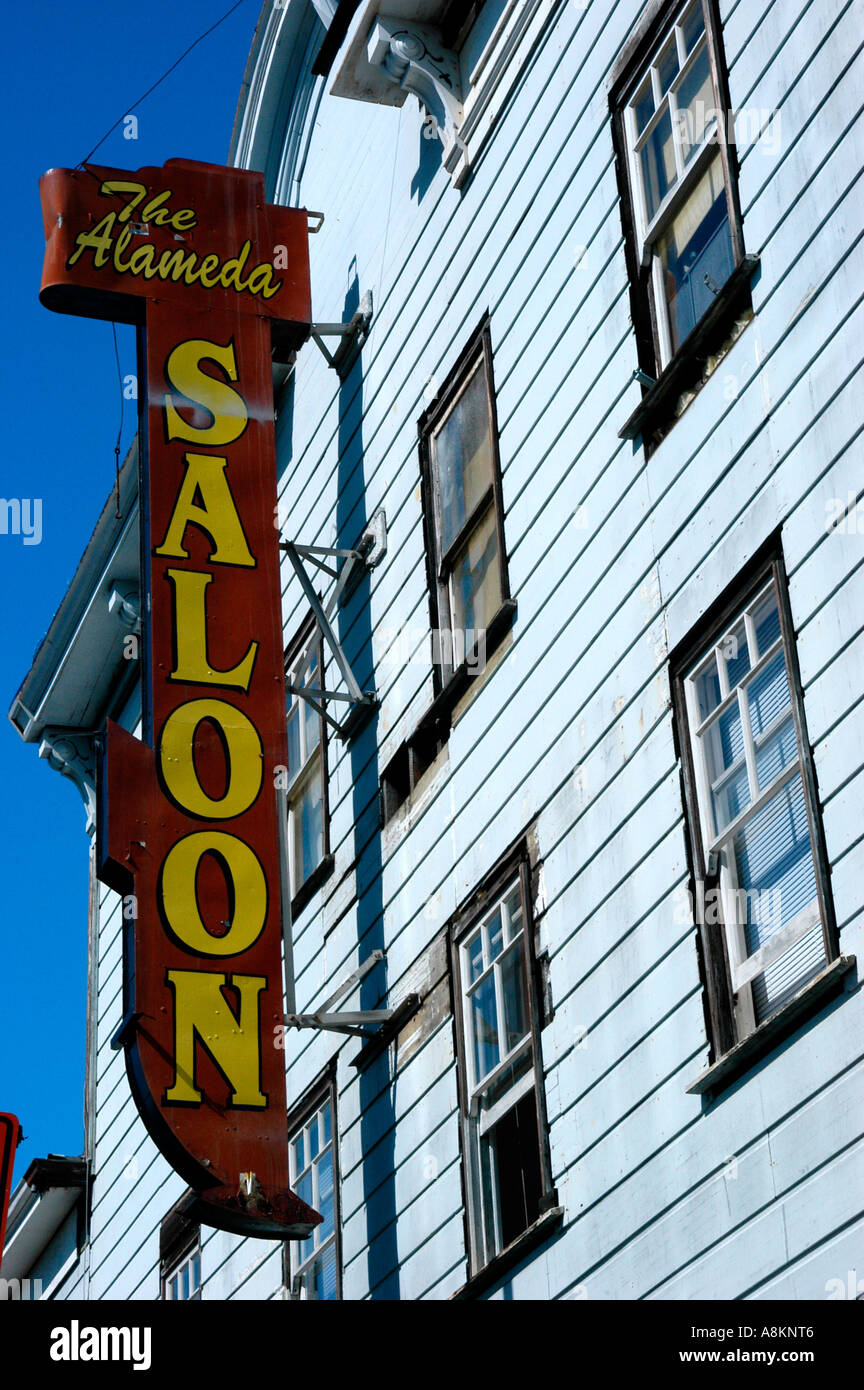 A large red Saloon sign on a historic wooden clapboard building in ...