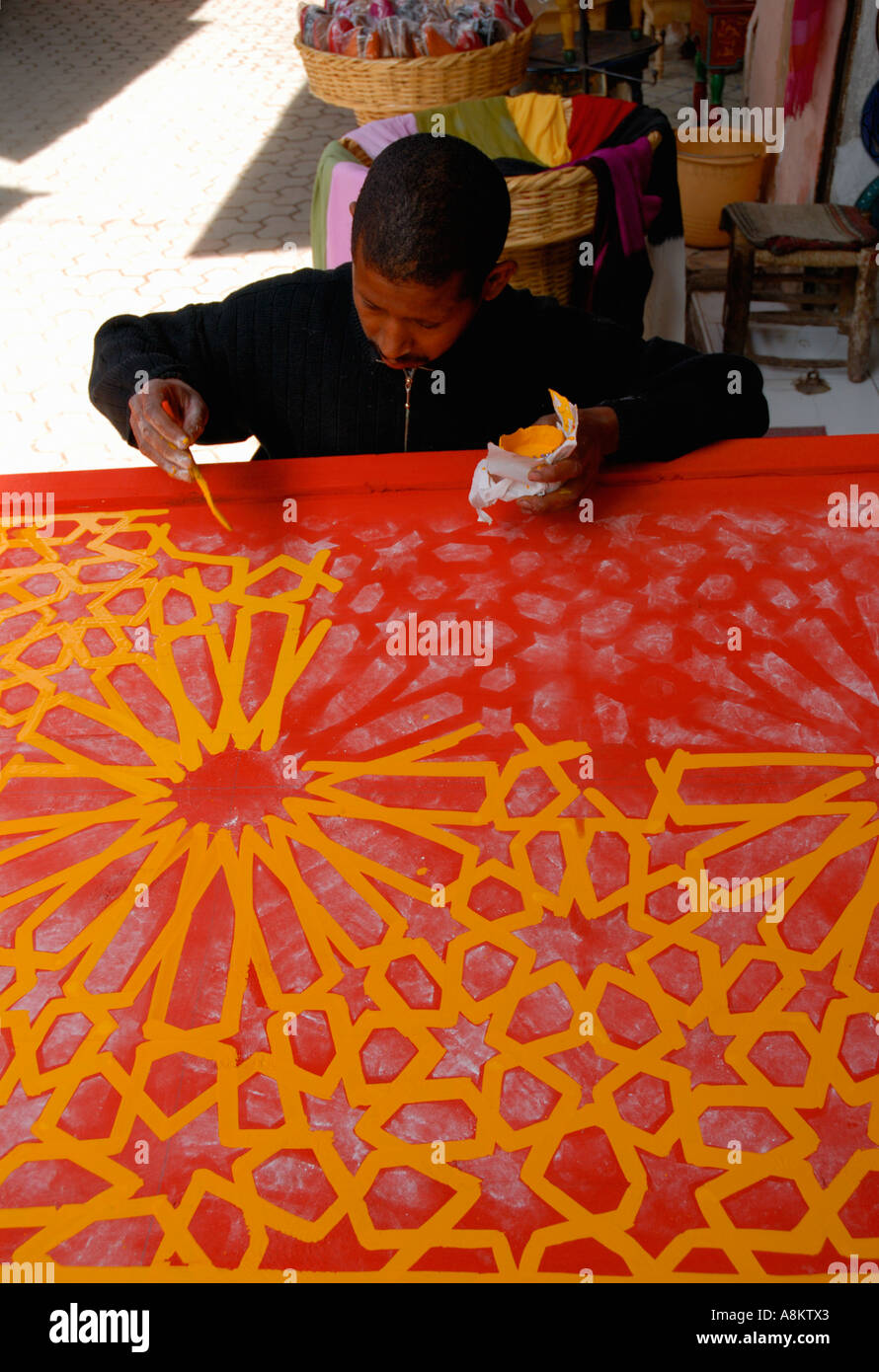 Craftsman painting in souk medina Marrakech Marrakesh Morocco North ...