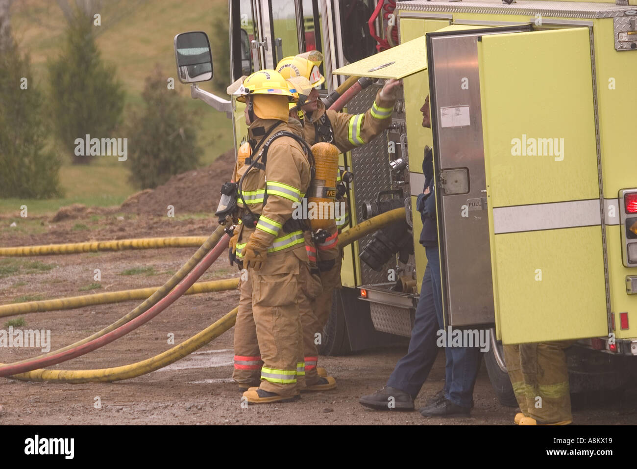 Fireman checking hoses hi-res stock photography and images - Alamy