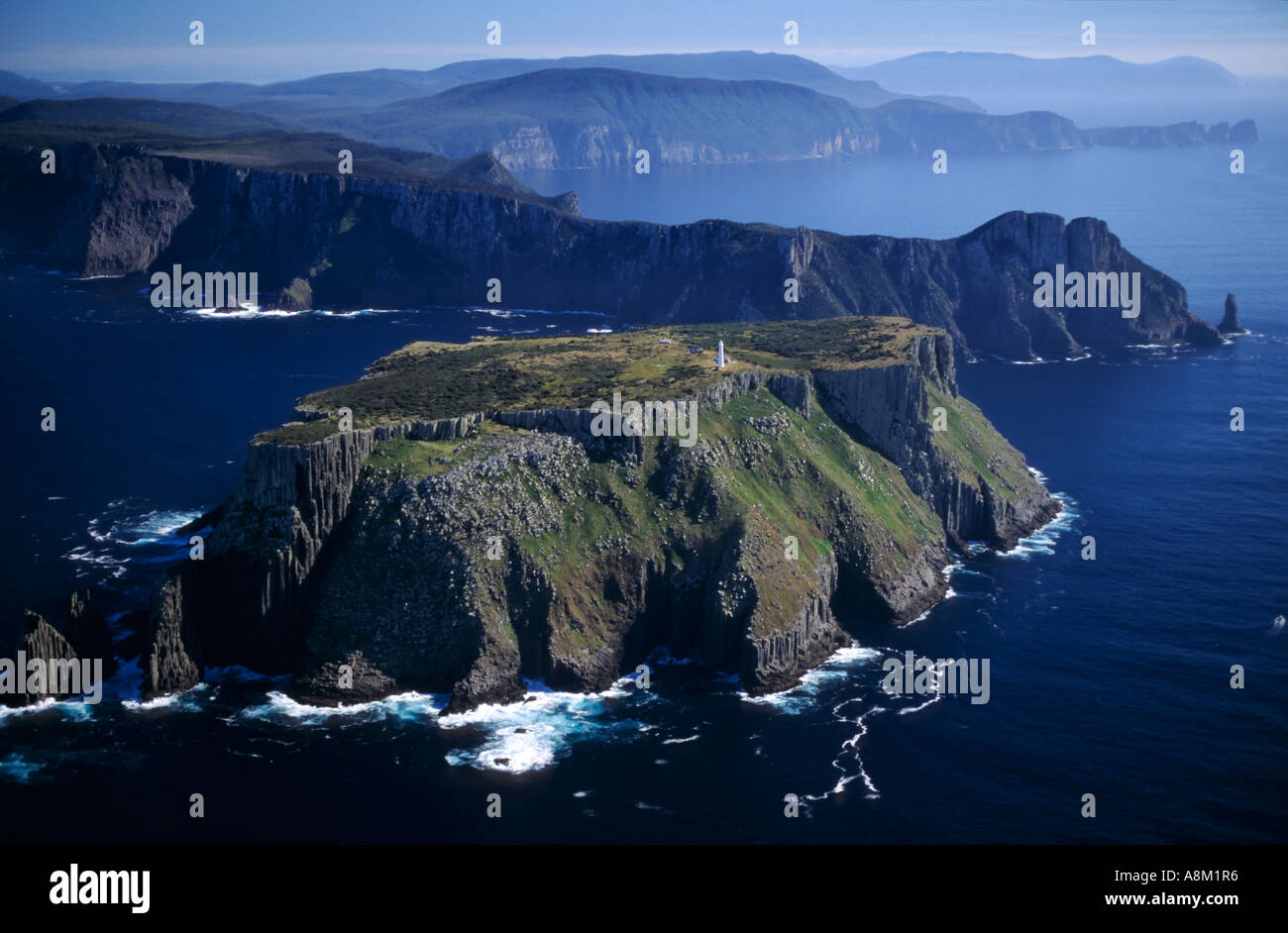 Tasman Island and lighthouse Cape Pillar behind Tasman Peninsula ...
