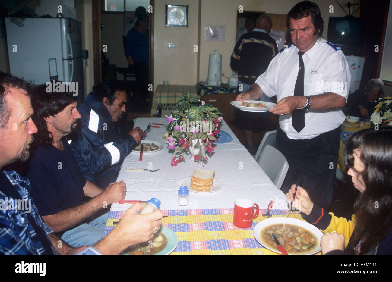 Member of the Salvation Army serving lunch to homeless people in ...