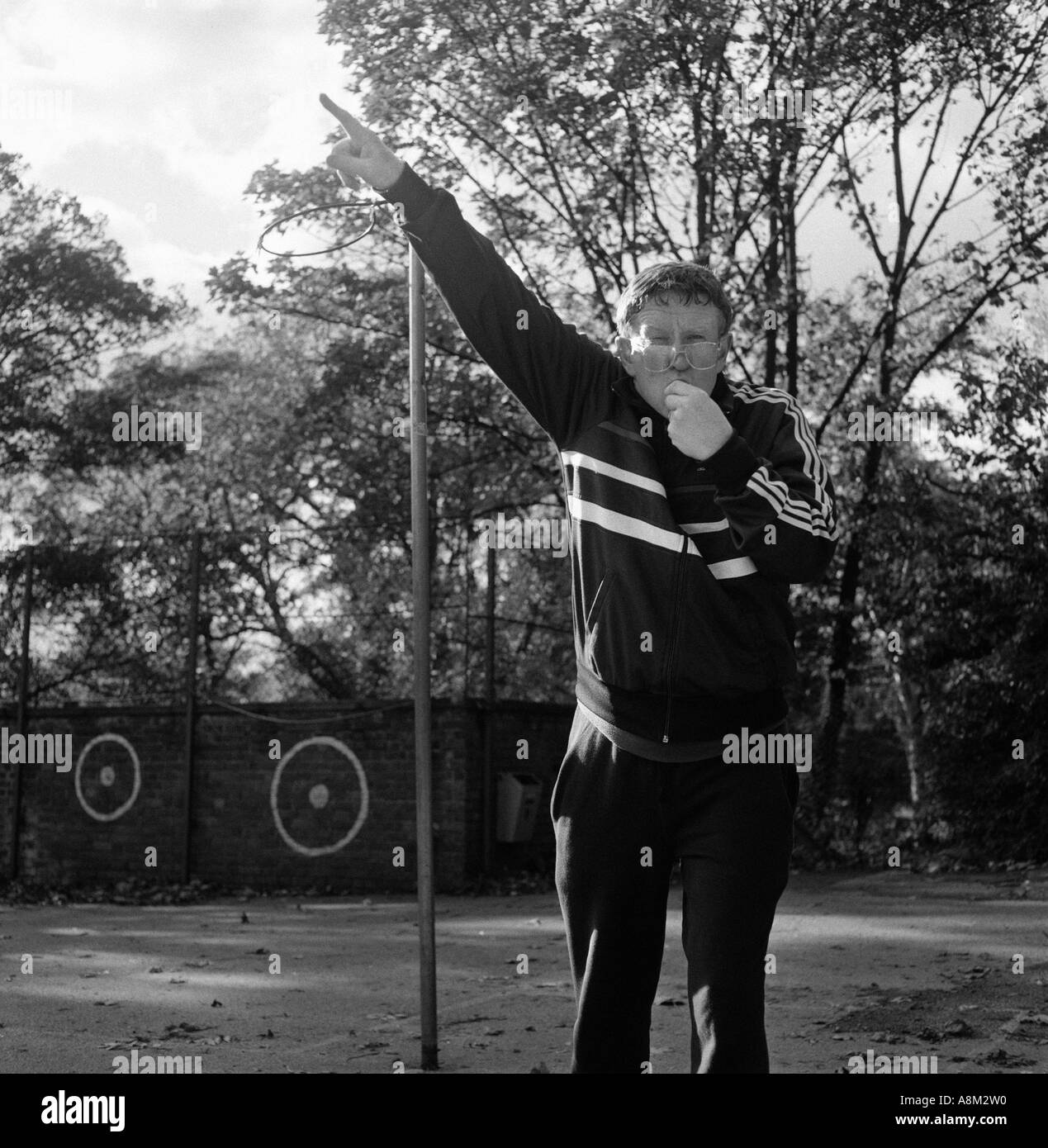 a sports teacher blowing a whistle POSED BY MODEL Stock Photo - Alamy