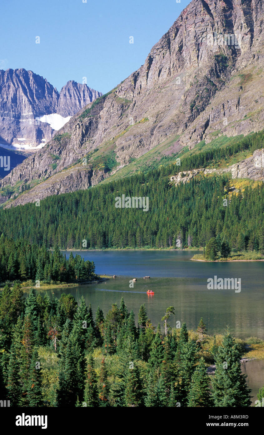 USA MONTANA View of Swift Current Lake and red canoe Glacier National ...
