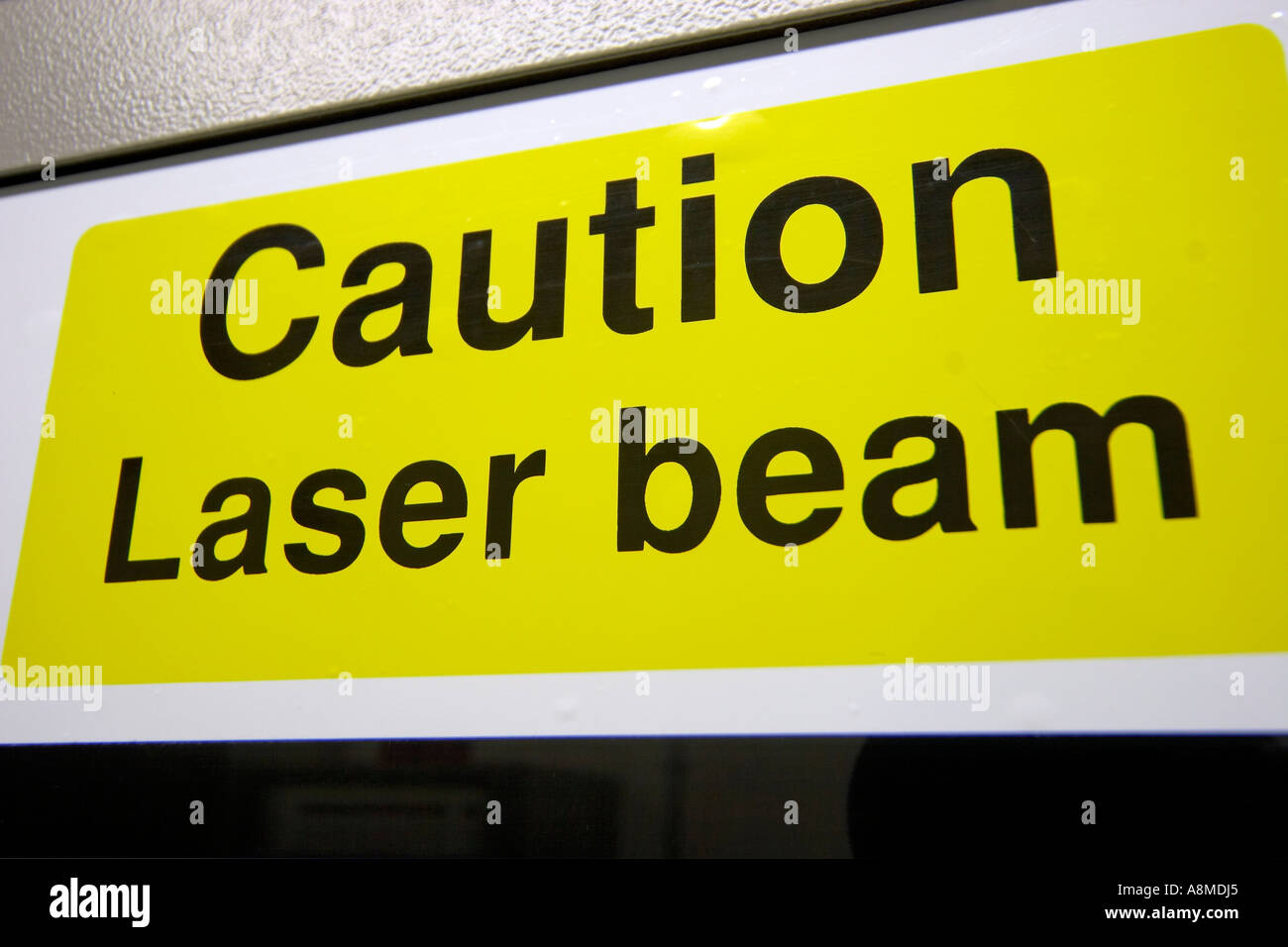 Caution Laser Beam warning sign notice Stock Photo - Alamy