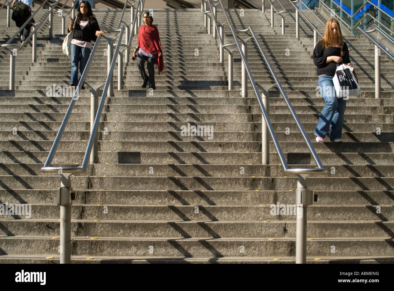 Horizontal view of several people walking up and down a large flight of ...