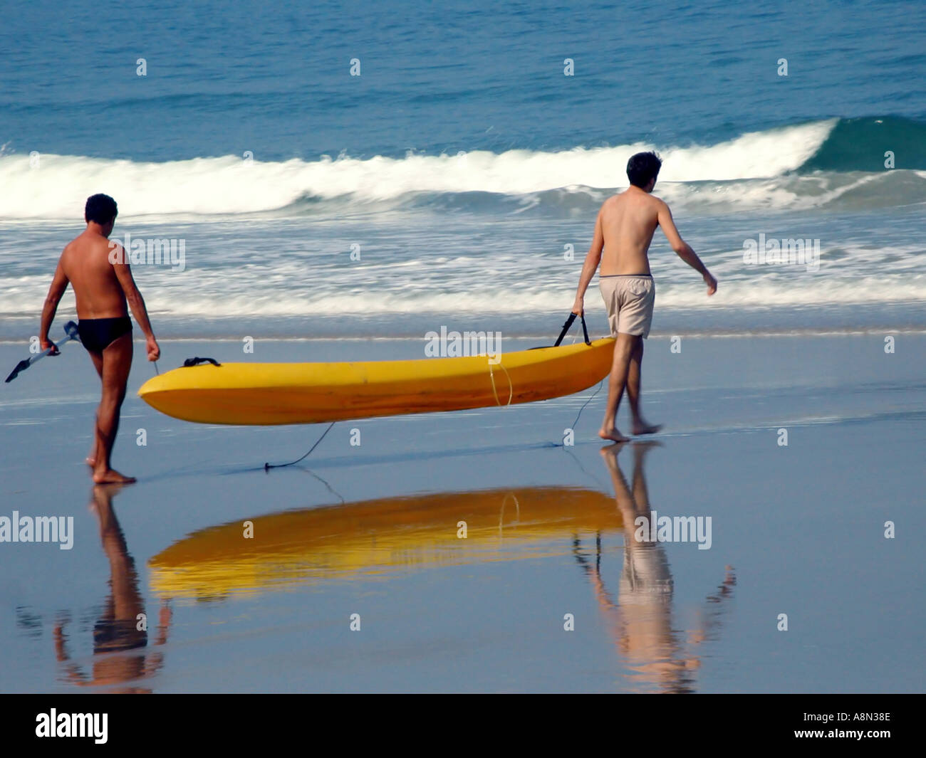 Men carrying boat for the sea Stock Photo - Alamy