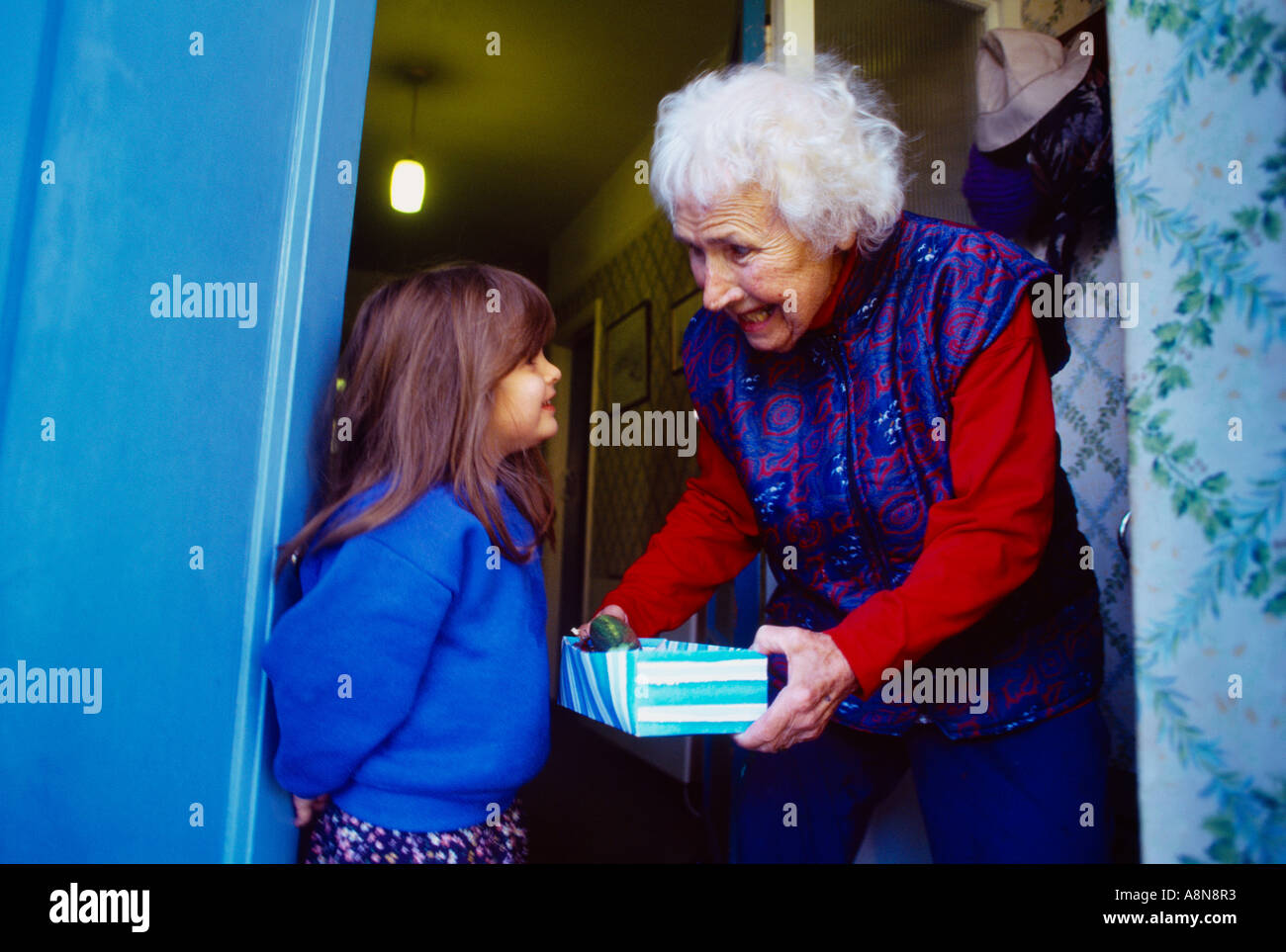 Giving Harvest Box To Old Lady Stock Photo - Alamy