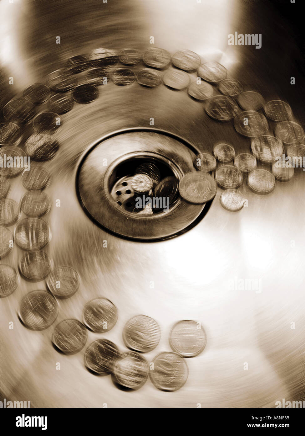 Money going down through a drain Stock Photo - Alamy