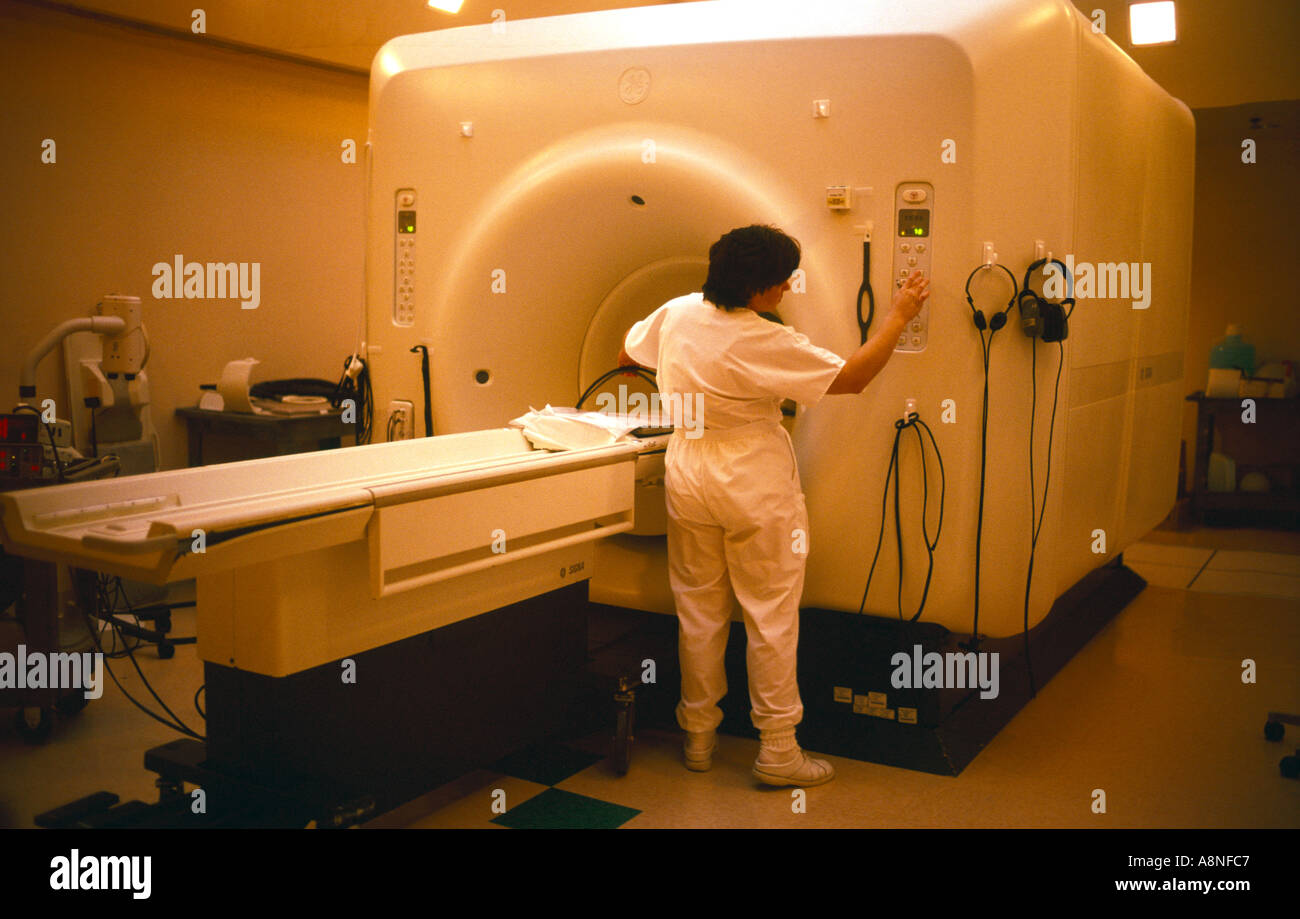 Magnetic Resonance Imaging MRI machine being adjusted by medical ...