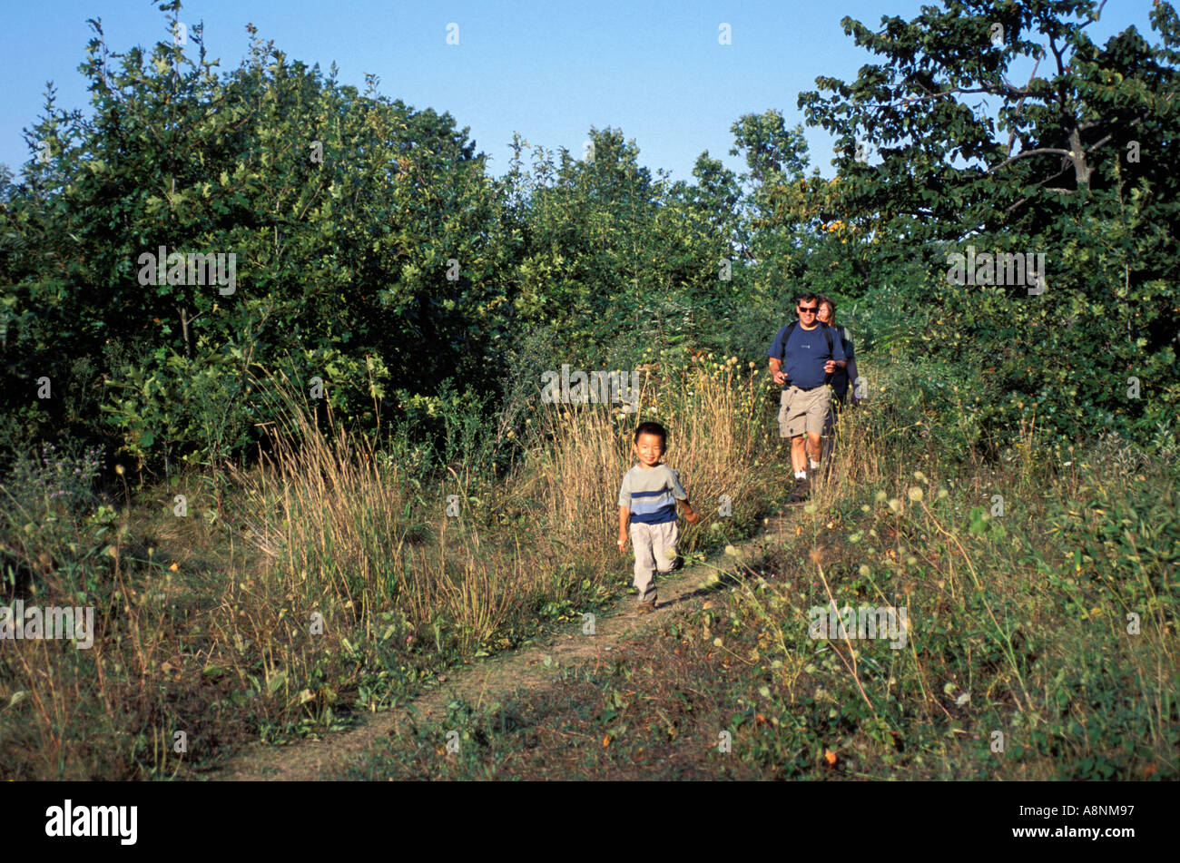 A family enjoys the trails at Adams Point a NH state wildlife reserve ...