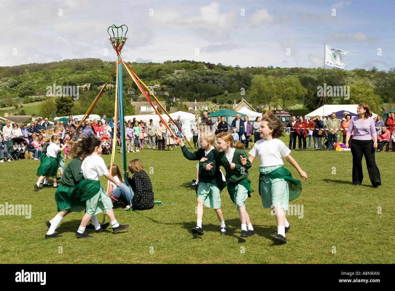 Primary school girls from Woodmancote School dancing around the Maypole ...